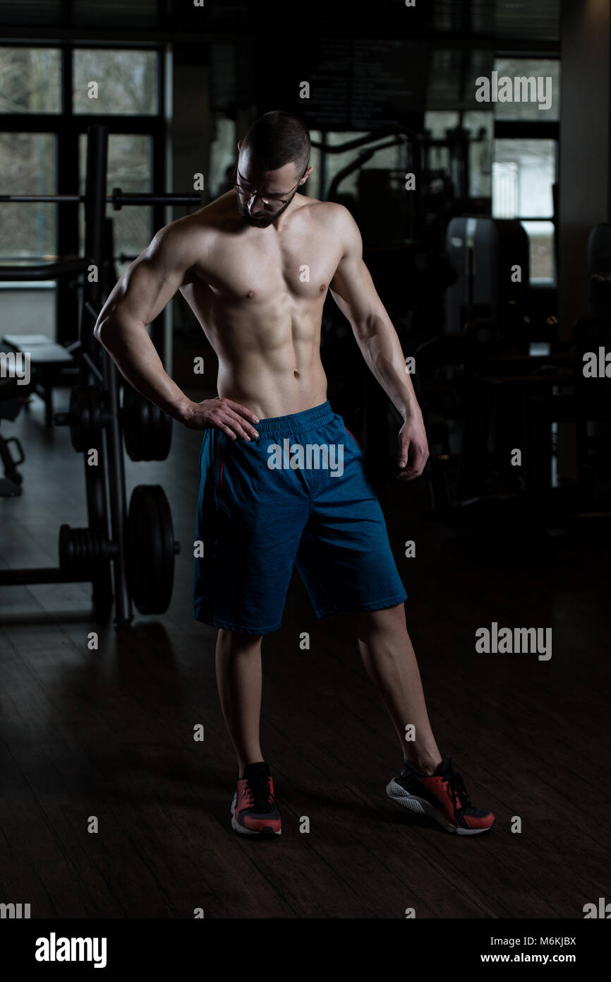 Portrait Of A Young Physically Fit Nerd Man Showing His Well Trained ...