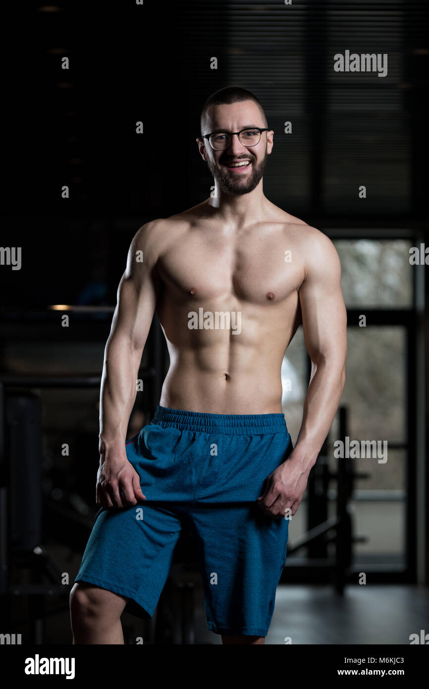 Portrait Of A Young Physically Fit Nerd Man Showing His Well Trained ...