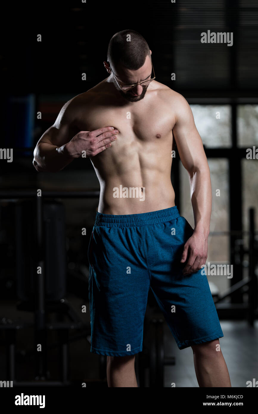 Portrait Of A Young Physically Fit Nerd Man Showing His Well Trained ...