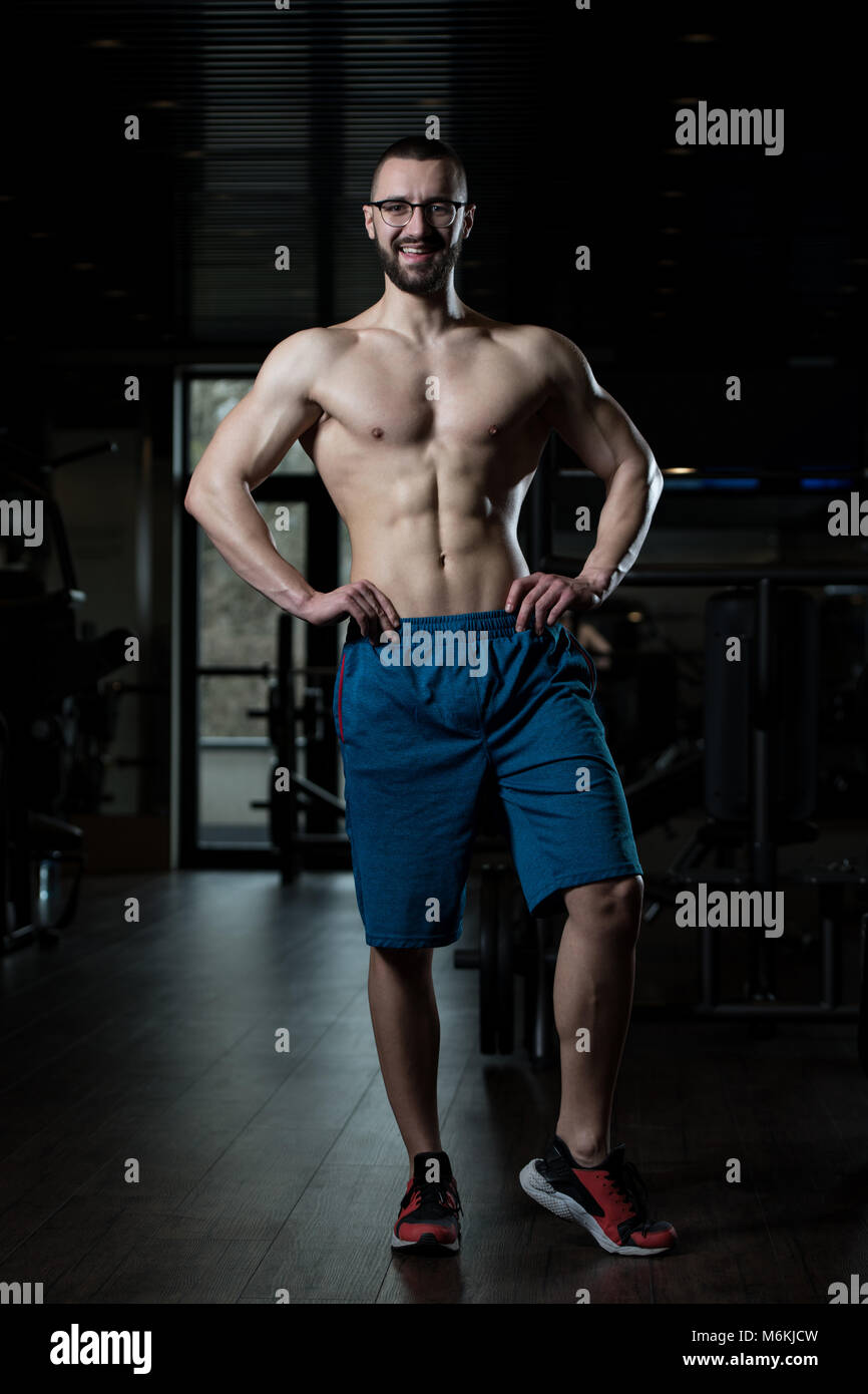 Portrait Of A Young Physically Fit Nerd Man Showing His Well Trained ...