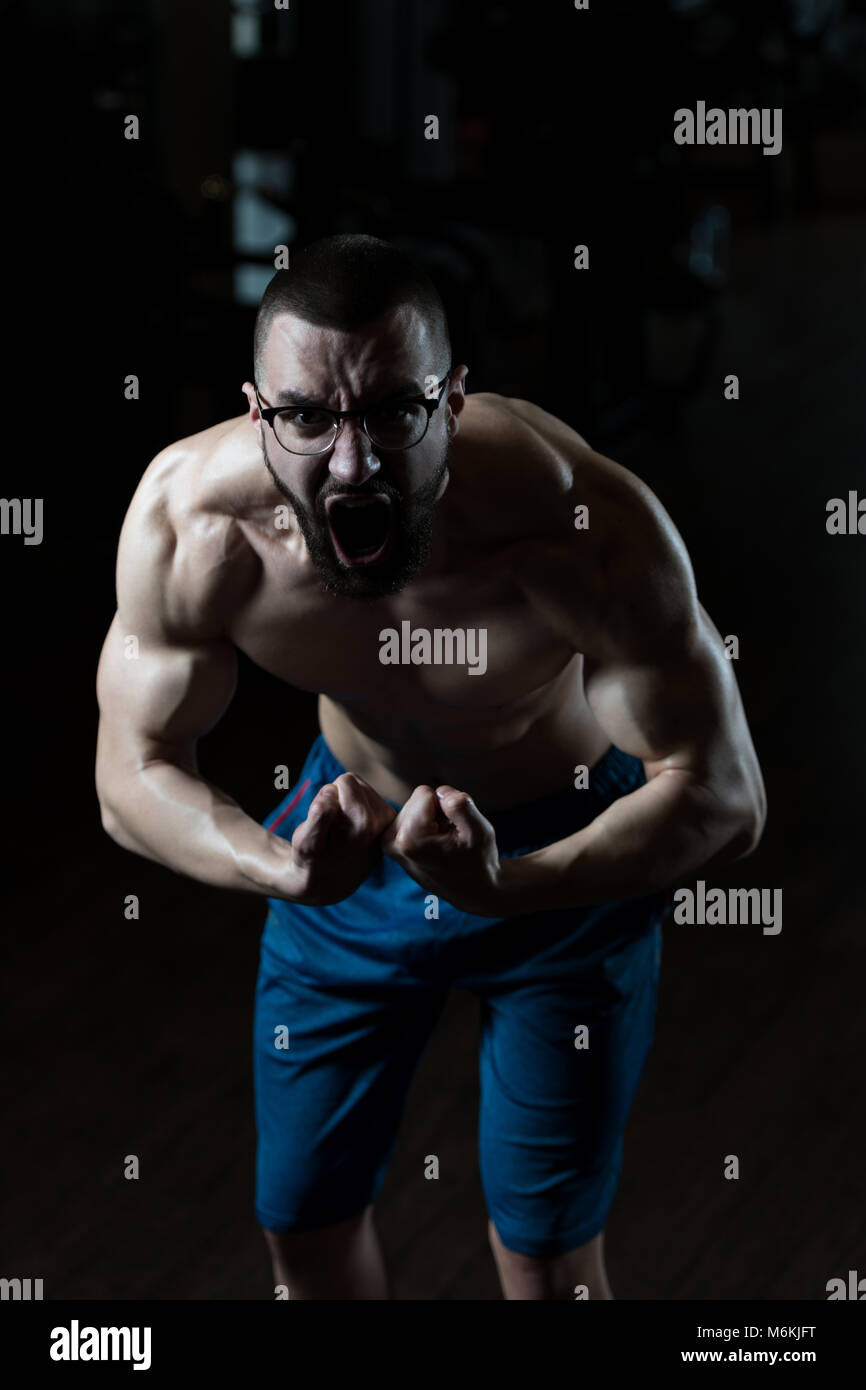 Portrait Of A Young Physically Fit Nerd Man Showing His Well Trained ...
