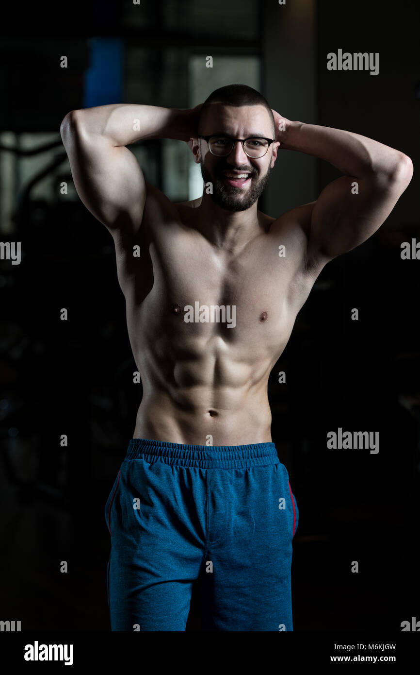 Portrait Of A Young Physically Fit Nerd Man Showing His Well Trained ...