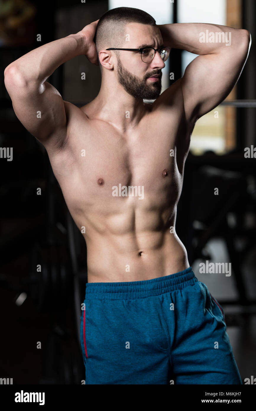 Portrait Of A Young Physically Fit Nerd Man Showing His Well Trained ...