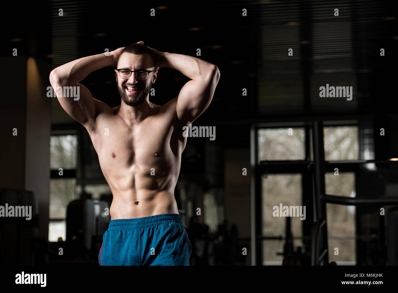 Portrait Of A Young Physically Fit Nerd Man Showing His Well Trained ...