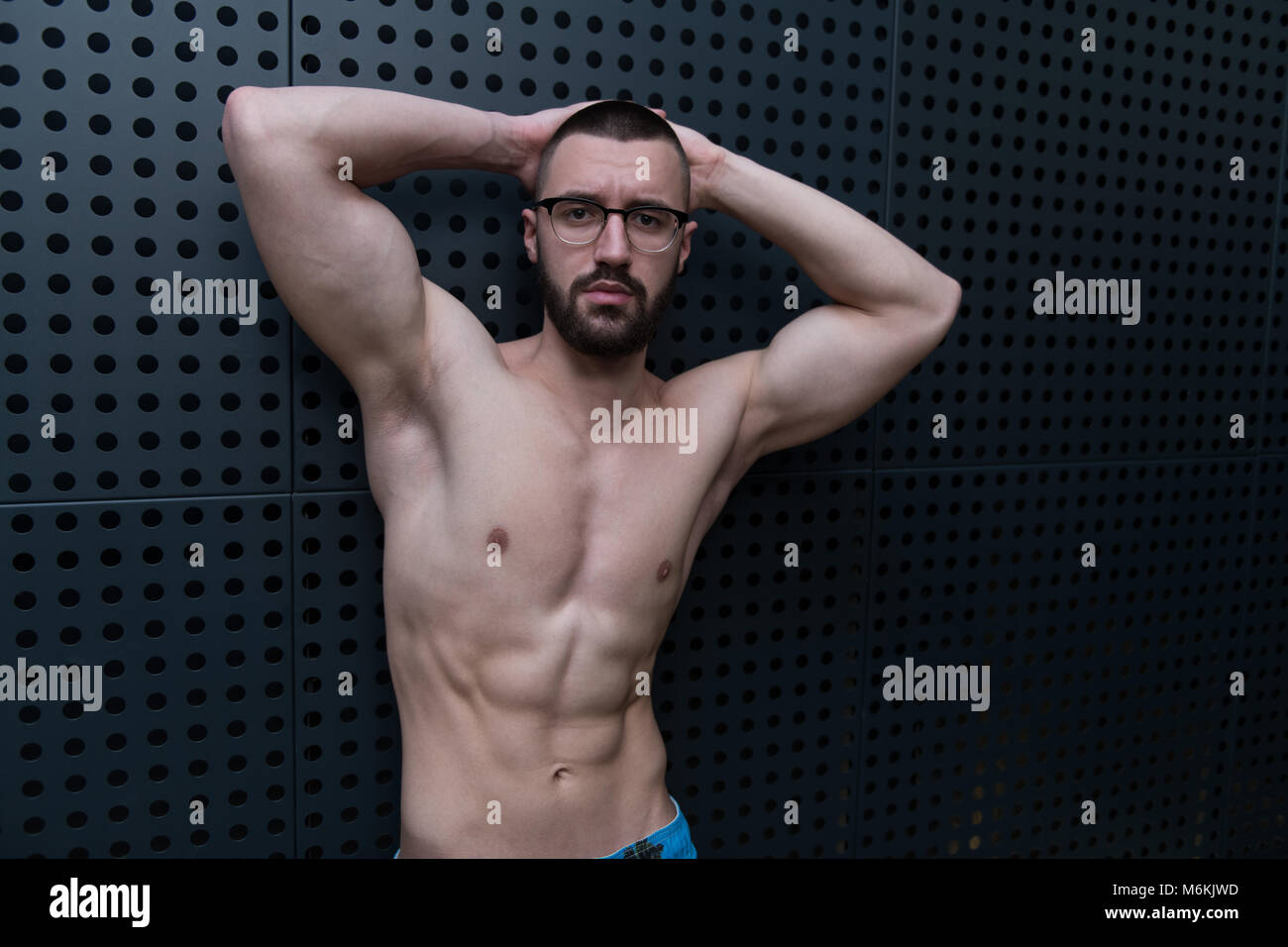 Healthy Young Man Standing Strong Standing Against a Wall and Flexing ...