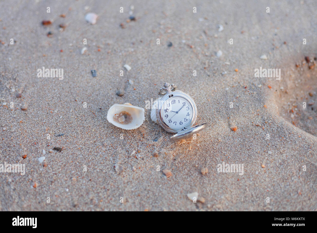 pocket watch on sea beach background Stock Photo - Alamy