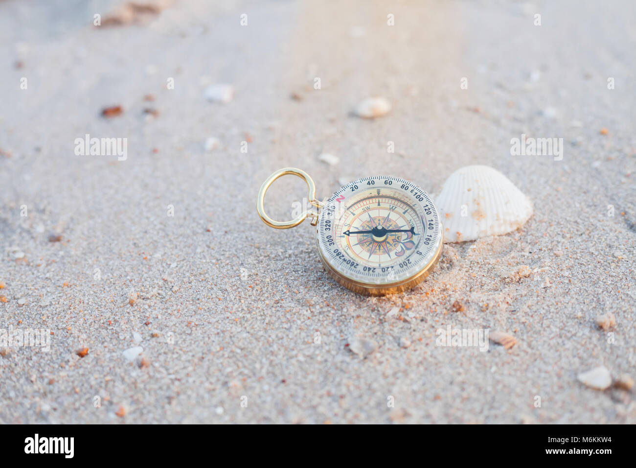 pocket compass on sea beach background Stock Photo - Alamy
