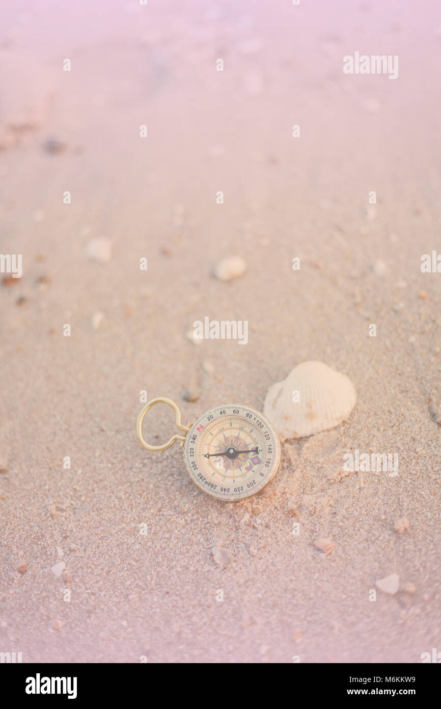 pocket compass on sea beach background Stock Photo - Alamy