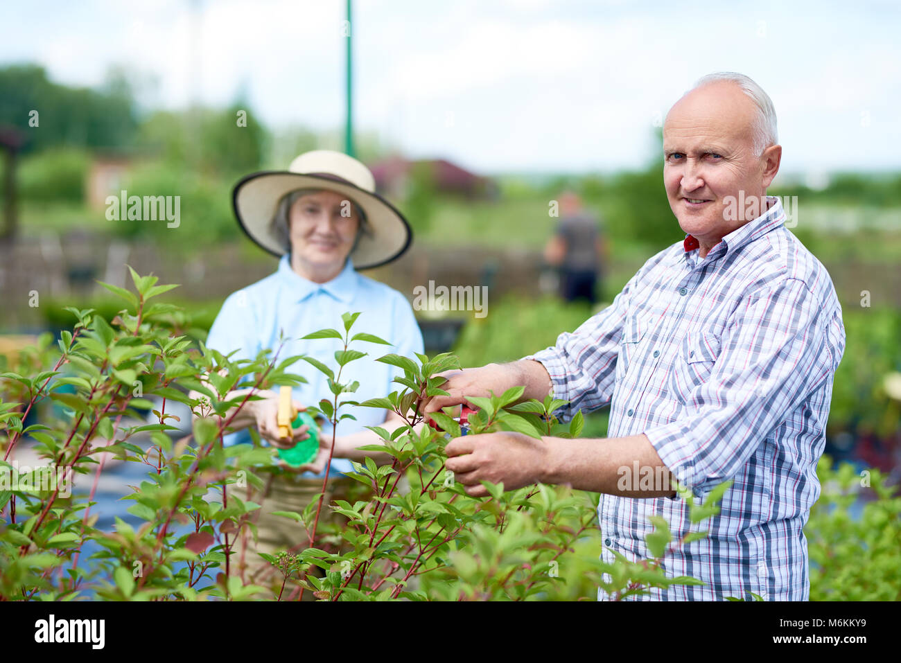 Couple of Happy Senior Farmers in Garden Stock Photo - Alamy