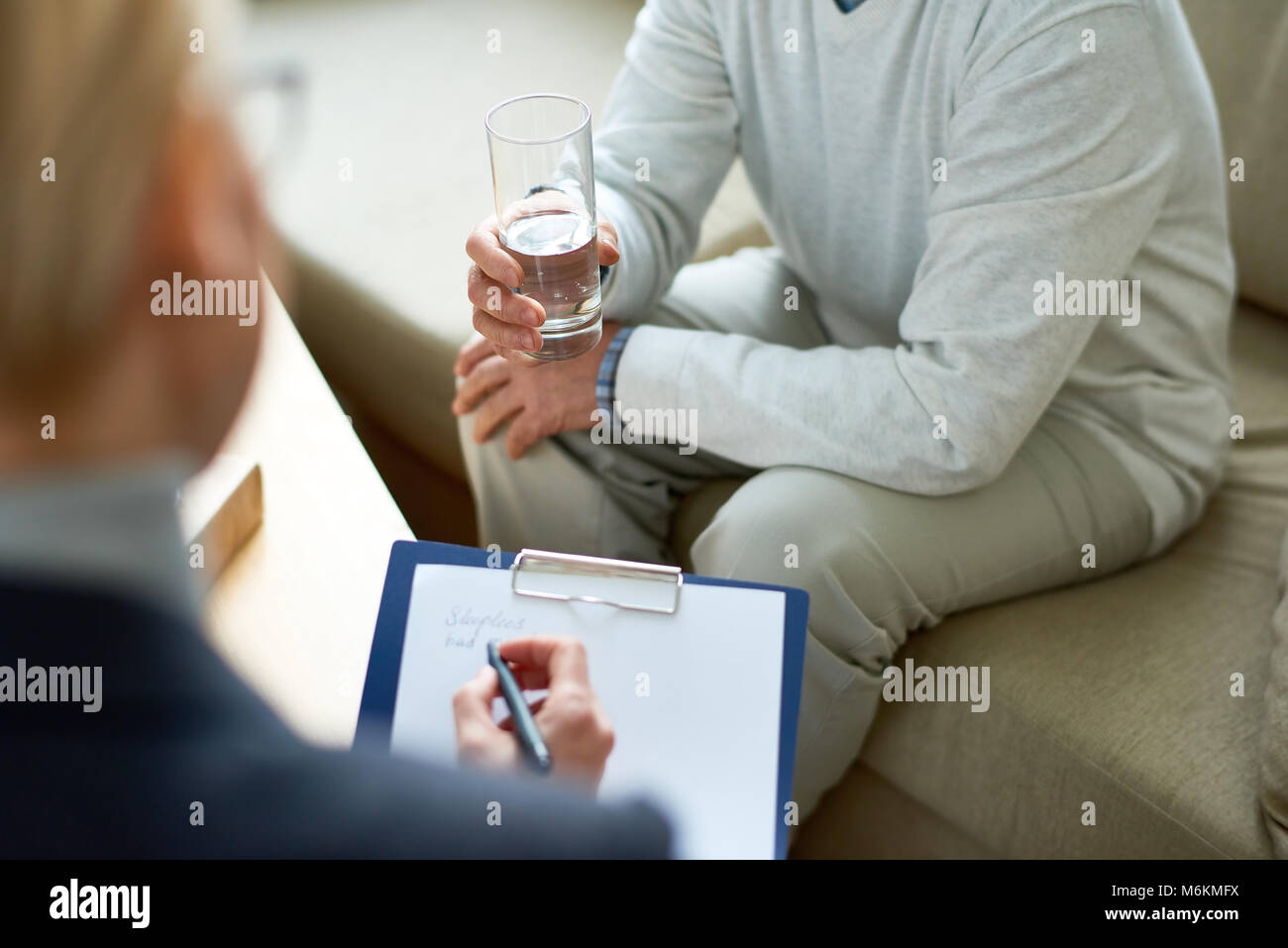 Psychologist Taking Notes in Meeting Stock Photo - Alamy