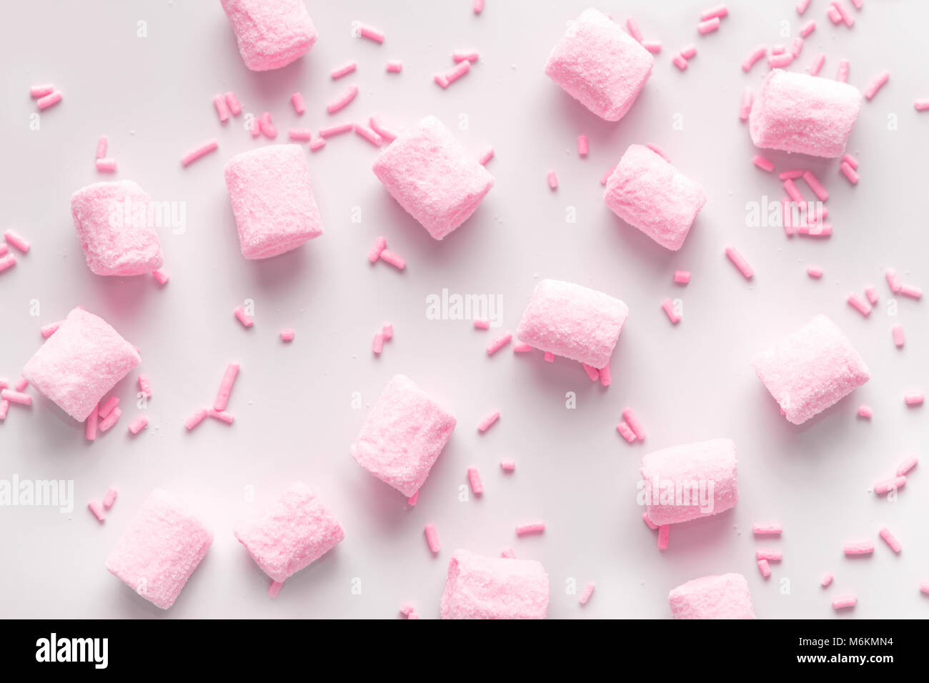 flat lay of beautiful marshmallows and sprinkles, soft pink background ...
