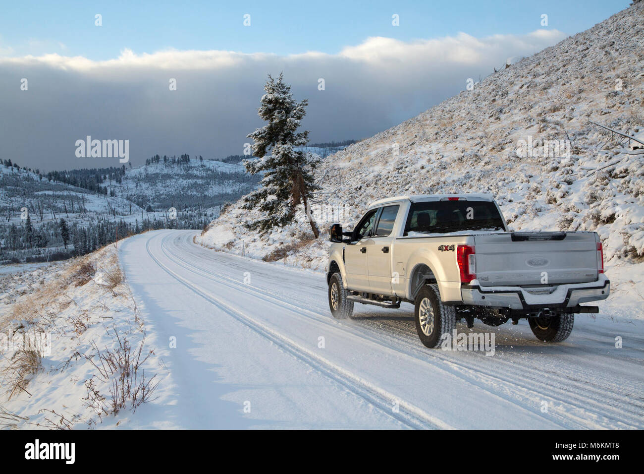 Snow-covered road near Tower Junction Stock Photo - Alamy