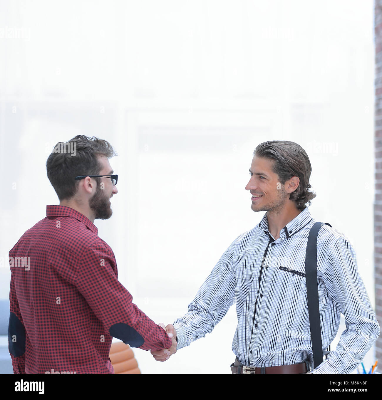 handshake two employees standing in the office Stock Photo - Alamy