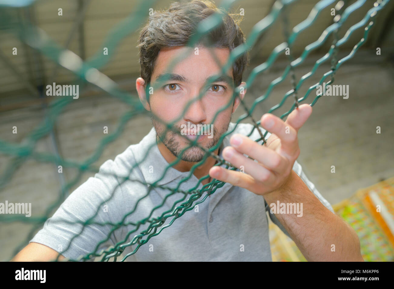 Worker through mesh hi-res stock photography and images - Alamy