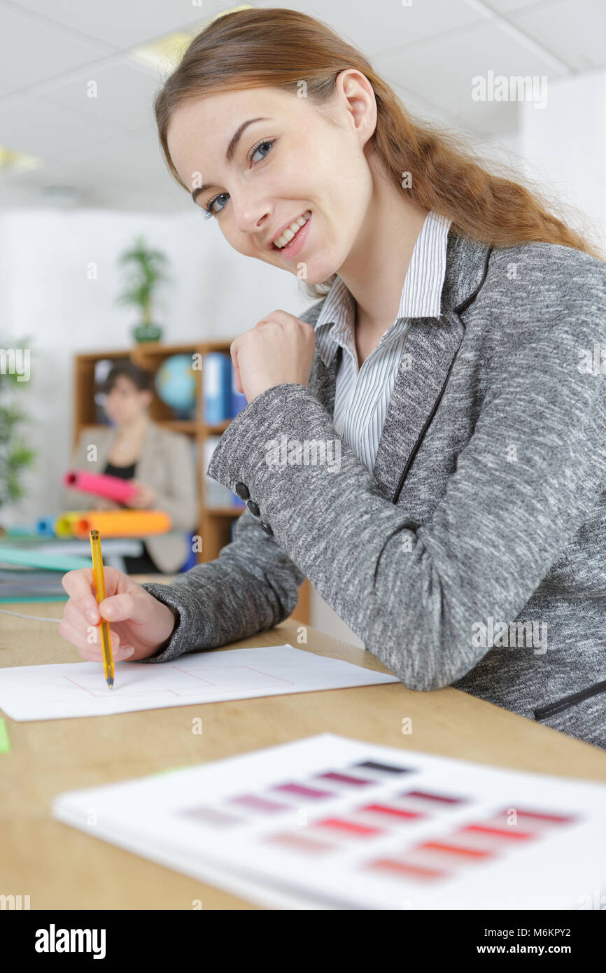 young female office worker with pen on paper Stock Photo - Alamy