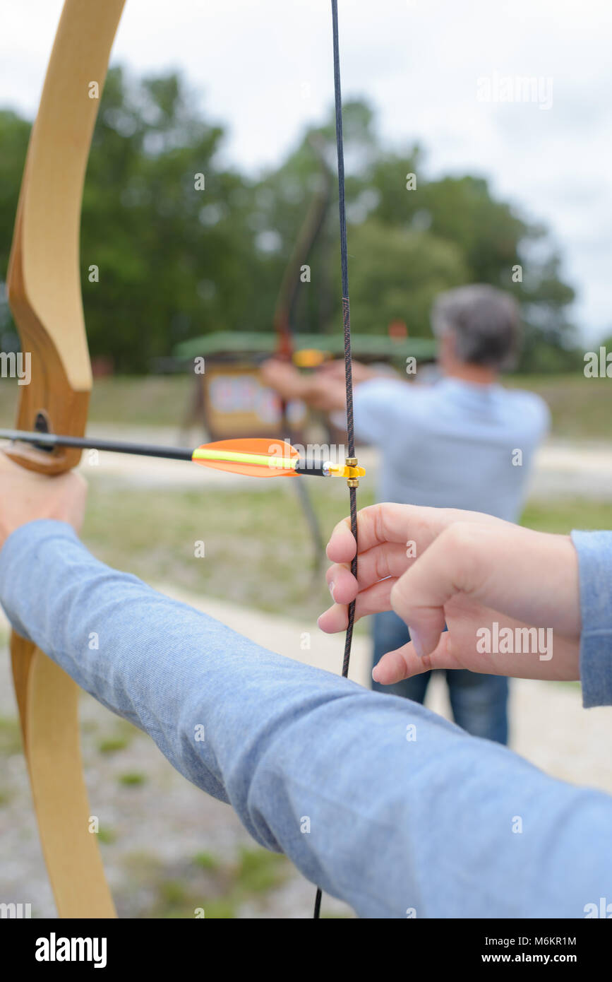 pulling the string of a bow Stock Photo - Alamy