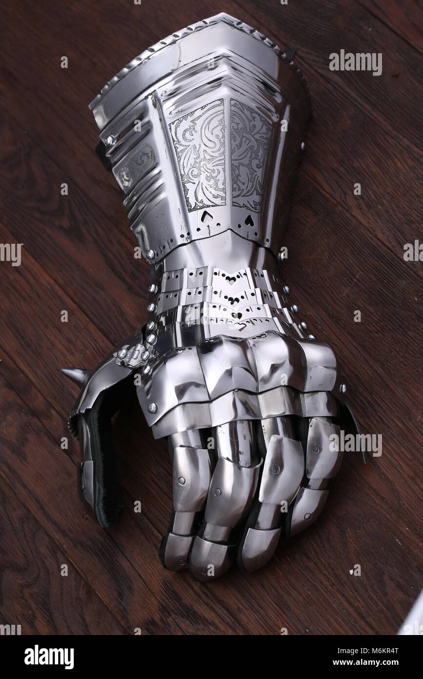 Medieval armor, detail of an ancient armor. Steel gloves on wooden ...