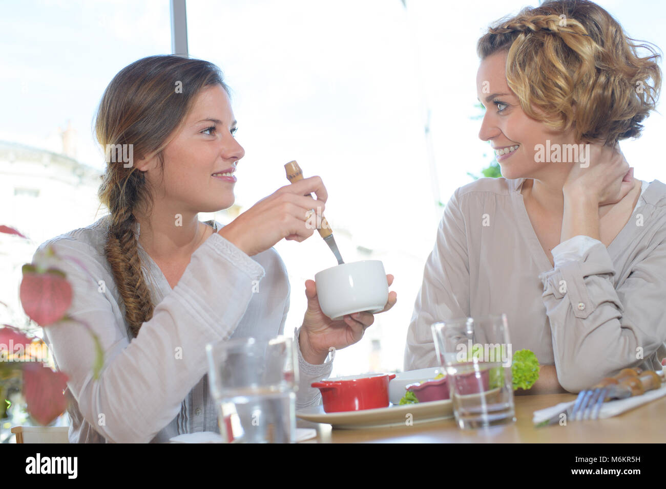 Friends eating together in a restaurant hi-res stock photography and ...