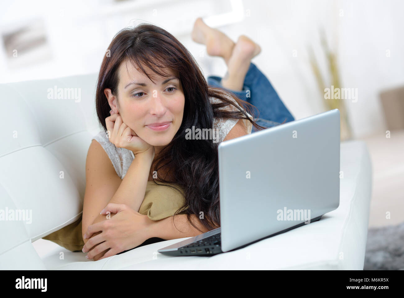 woman relaxing in front of her laptop Stock Photo - Alamy