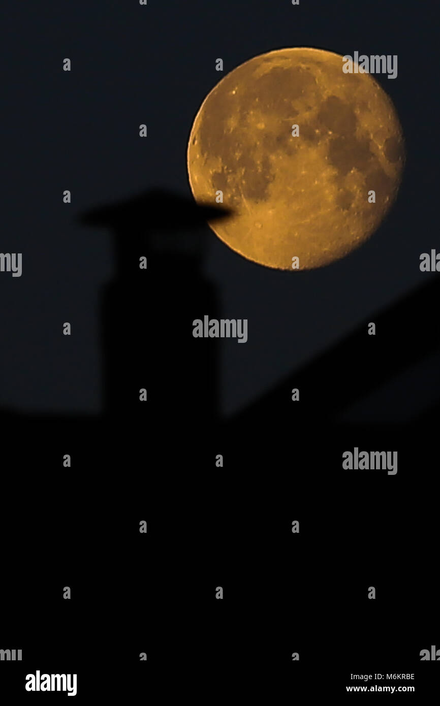 Full moon setting over north London Featuring: atmosphere Where: London ...