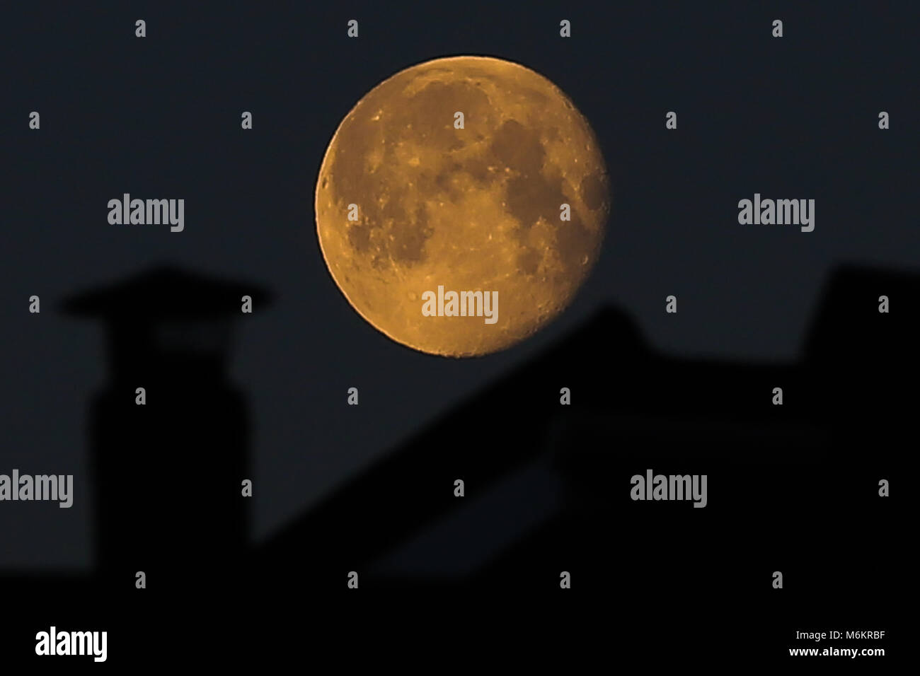 Full moon setting over north London Featuring: atmosphere Where: London ...