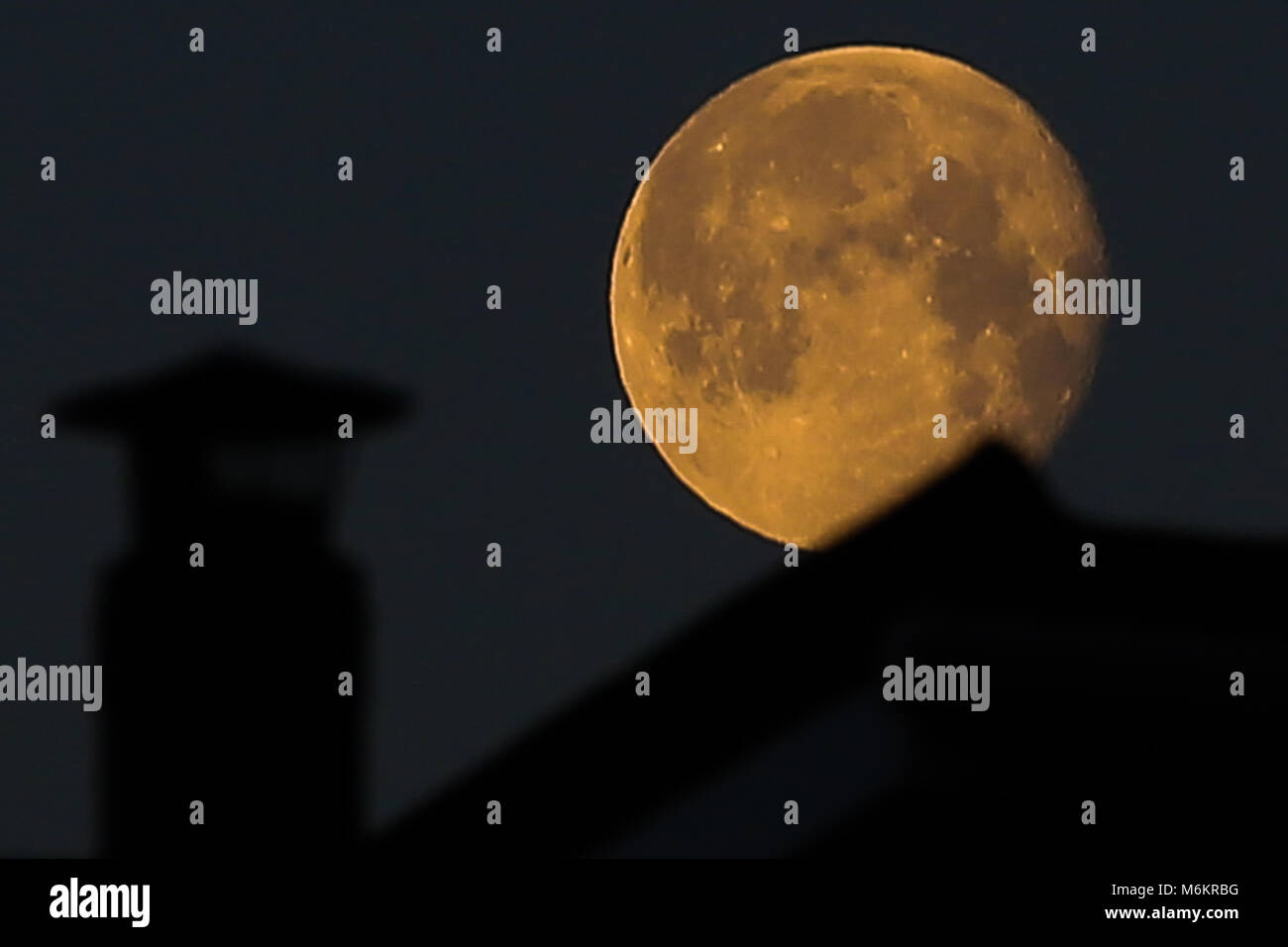 Full moon setting over north London Featuring: atmosphere Where: London ...