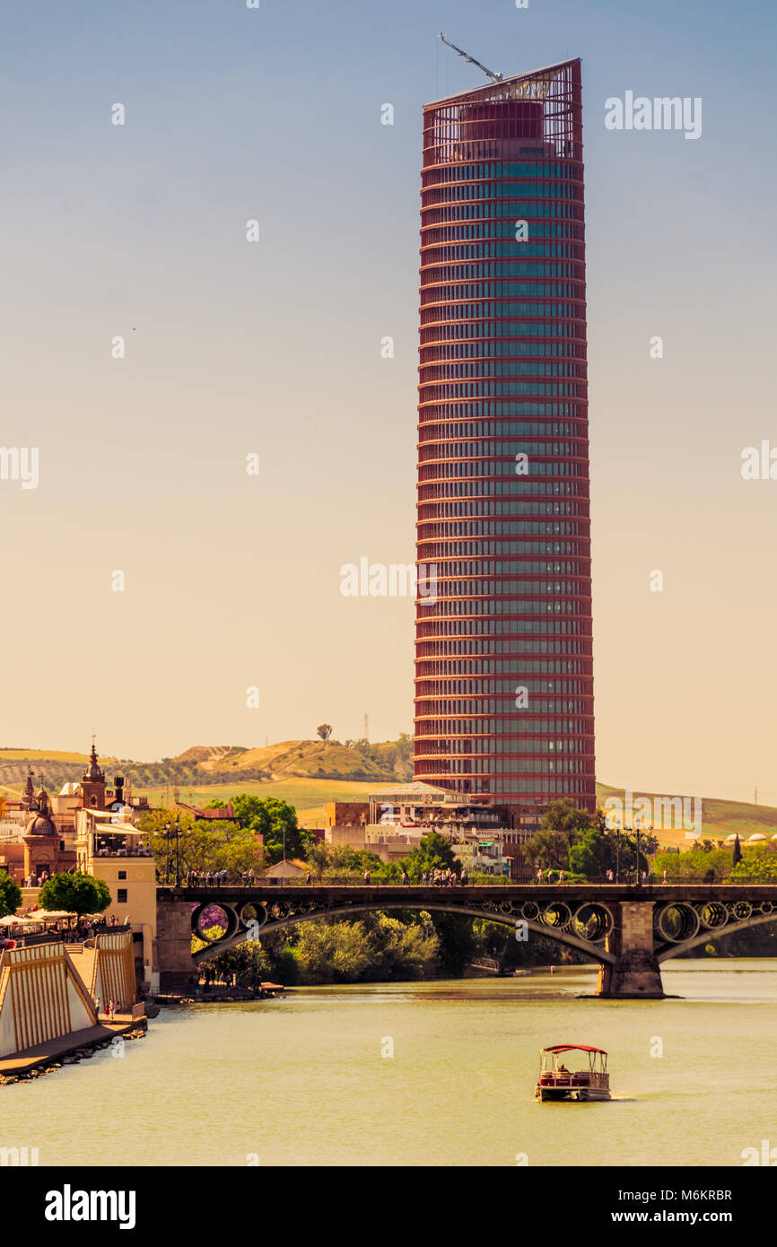 Riverside of Sevilla with trees in blossom at the sunset and the ...