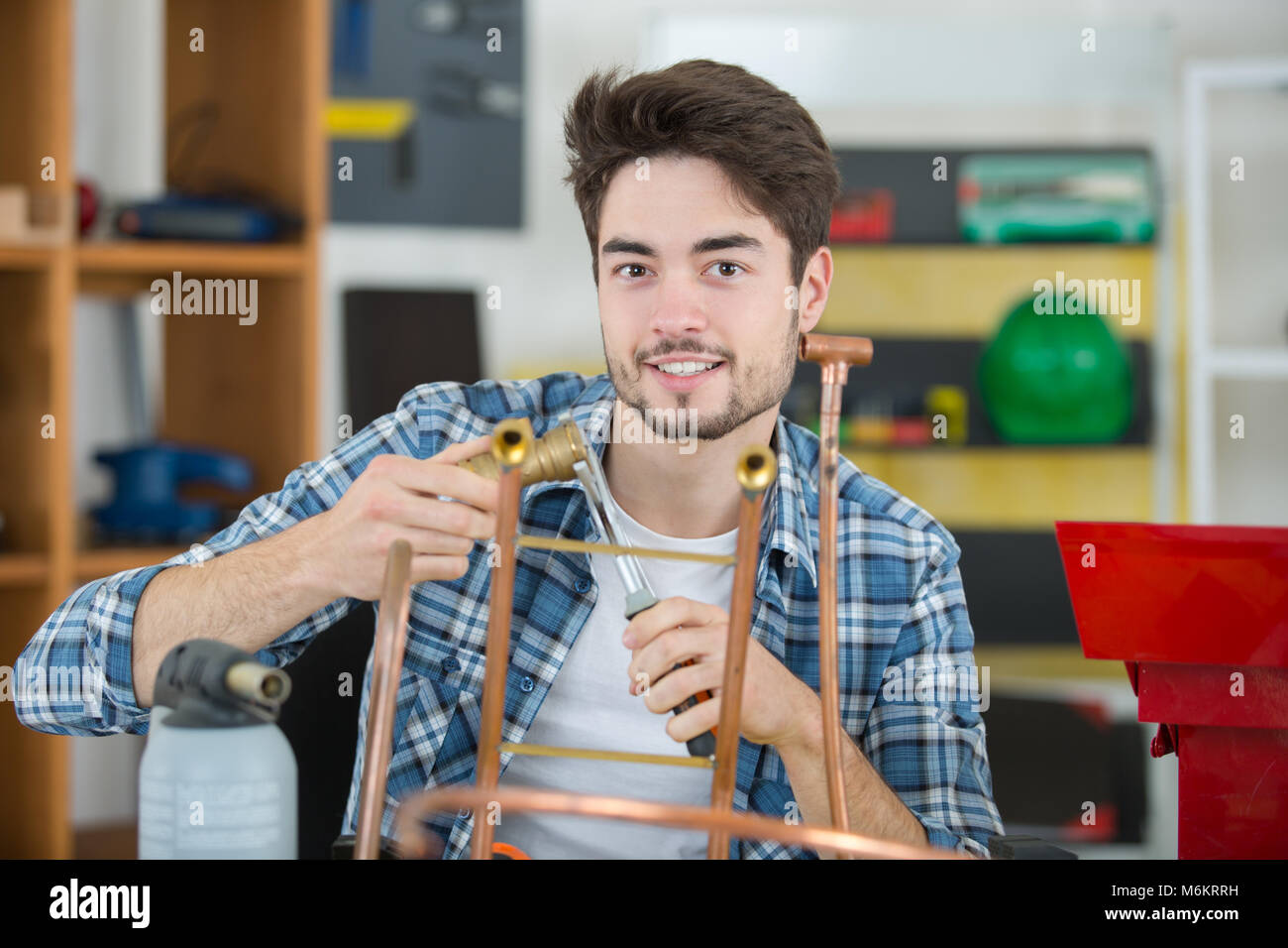 young man soldering copper fittings Stock Photo - Alamy