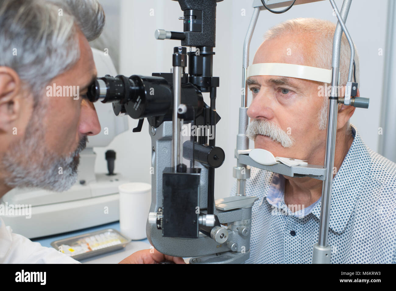 senior taking an eye test examination at opticians Stock Photo - Alamy