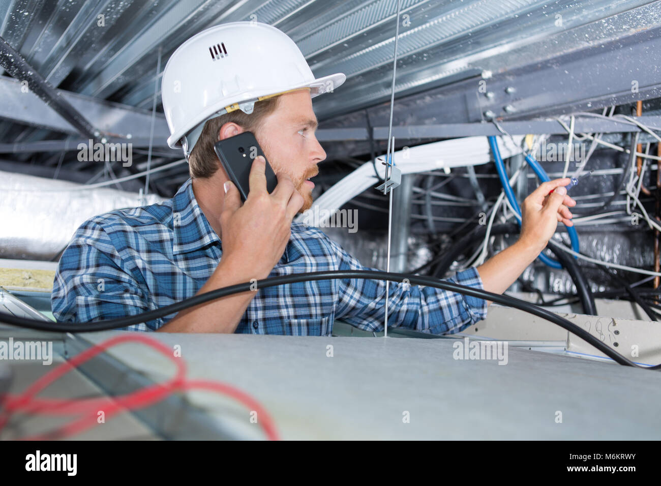 fixing cables on the ceiling Stock Photo - Alamy