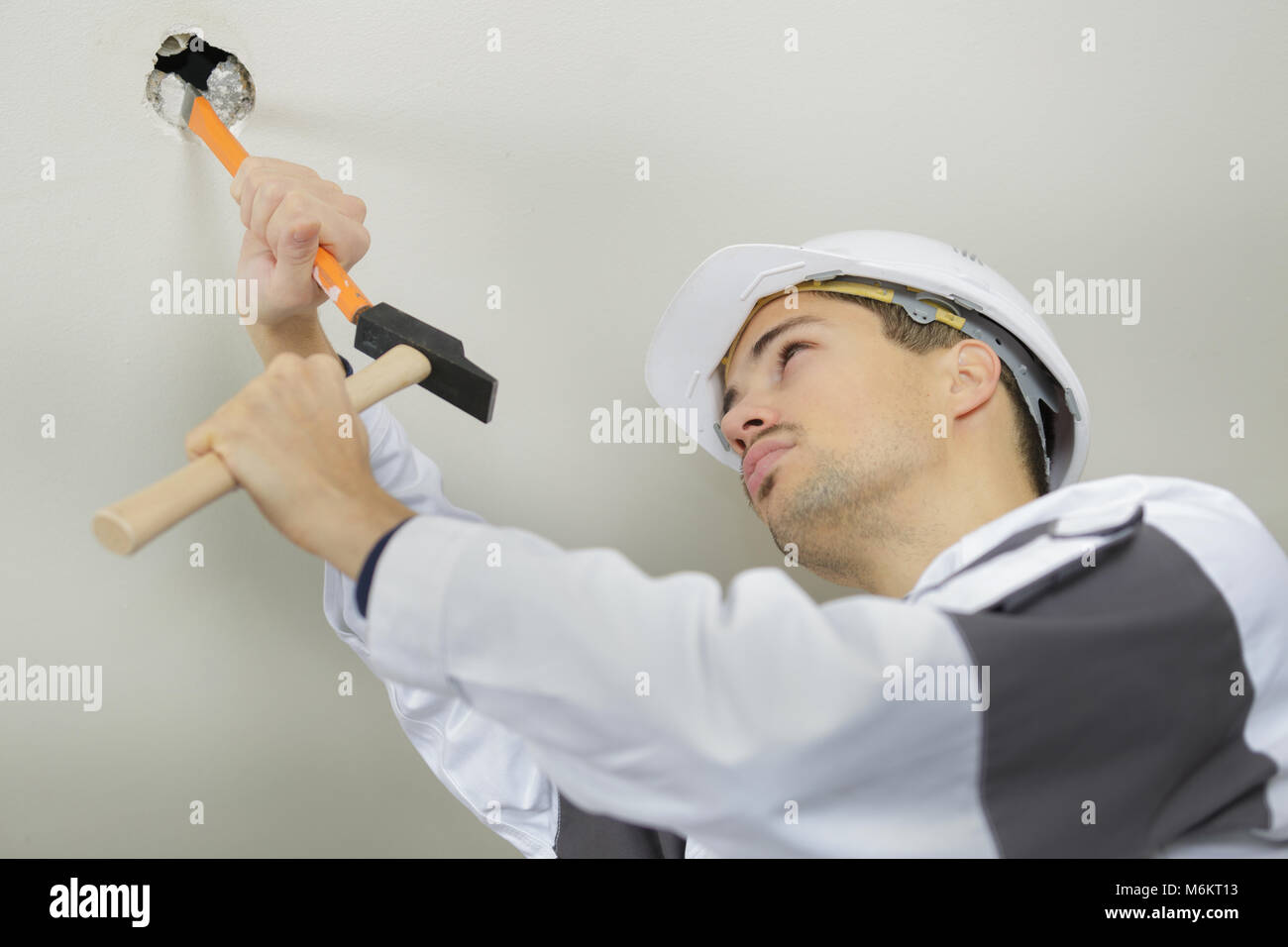 young man with a chisel and hammer Stock Photo - Alamy