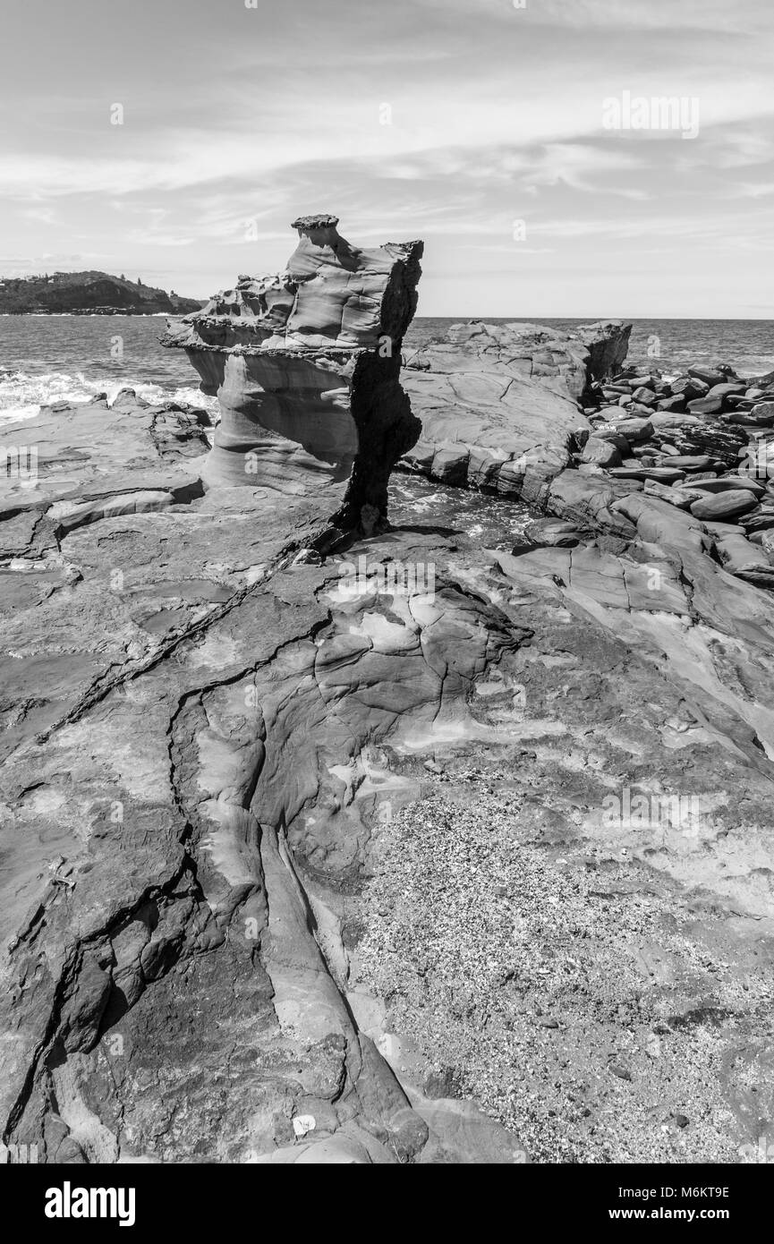 Vertical monohrome of sandstone rock formations and ocean. Avoca Beach ...