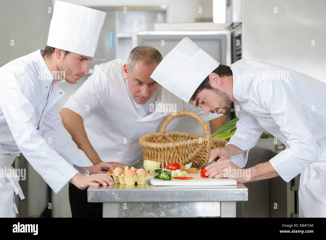 professional chefs preparing a dish at restaurant Stock Photo - Alamy