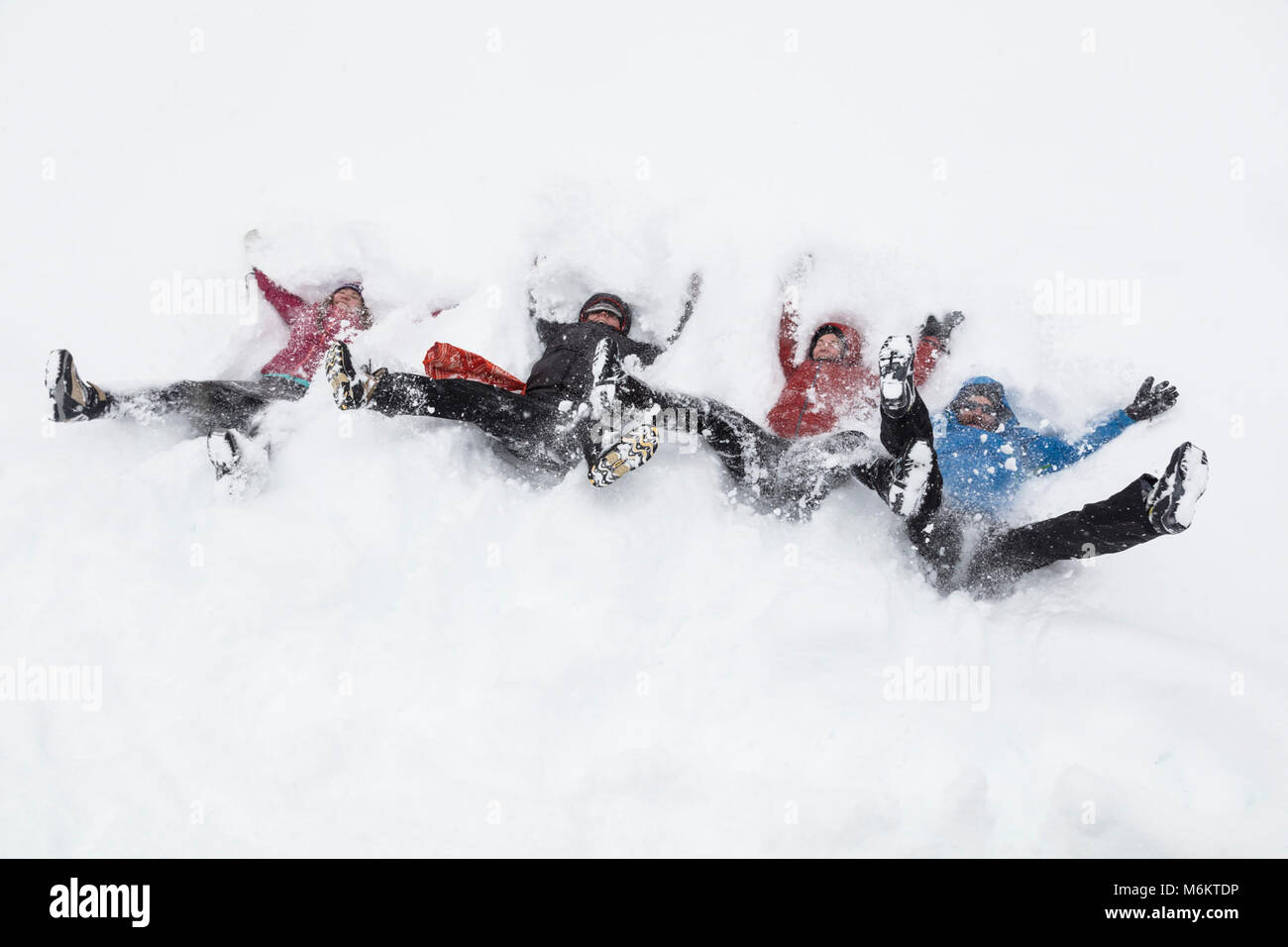 Group making snow angels at Canyon Stock Photo - Alamy