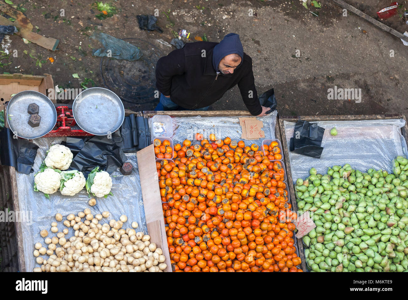Ramallah, Palestine, January 12, 2011: A man selling fresh fruits and ...