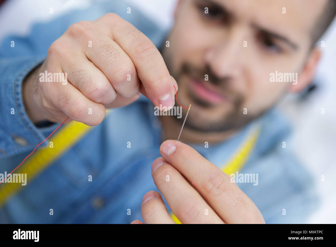 closeup of tailor threading needle Stock Photo - Alamy