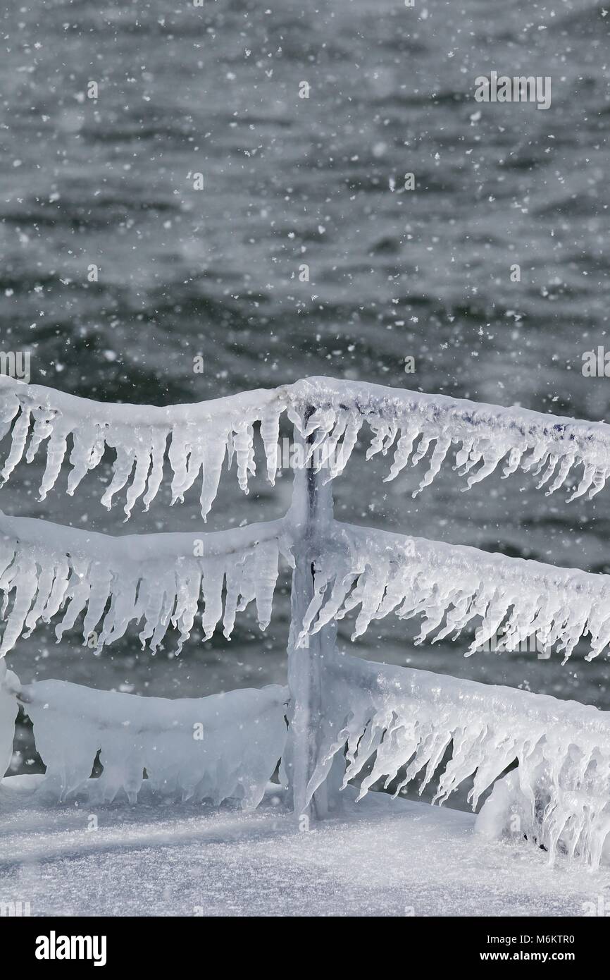 Huge icicles formed by waves hanging on frozen ship's rail, Baltic Sea ...