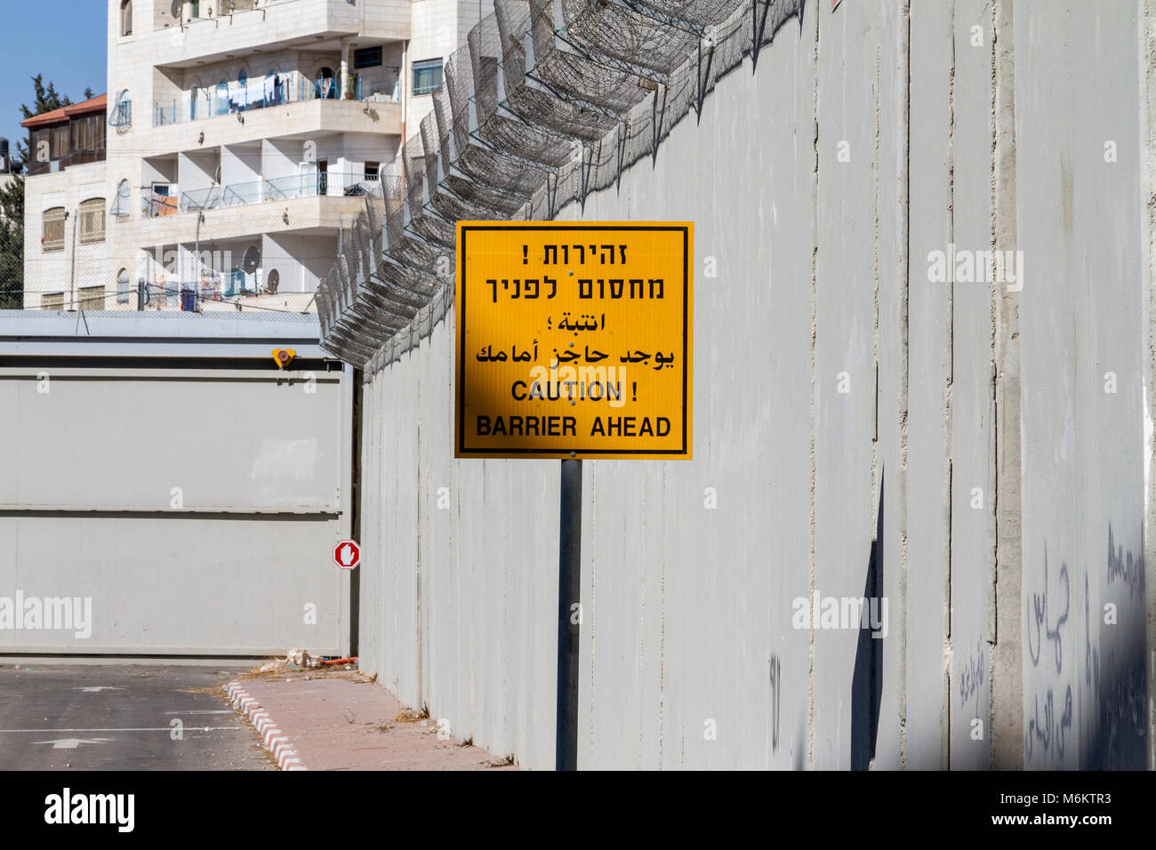 Jerusalem, Israel, November 23, 2010: Road sign by the concrete wall ...