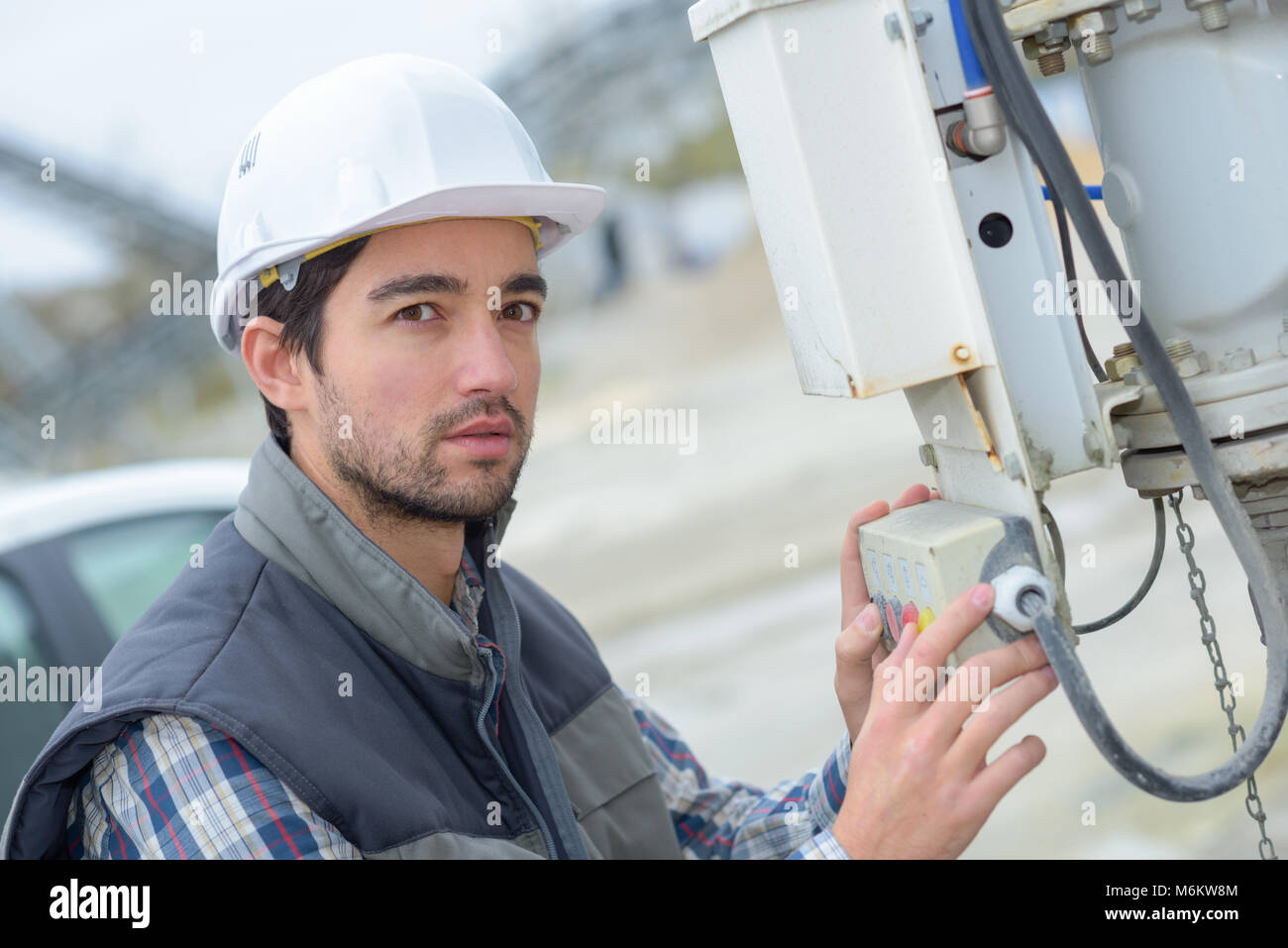 Portrait of man operating machinery on construction site Stock Photo ...