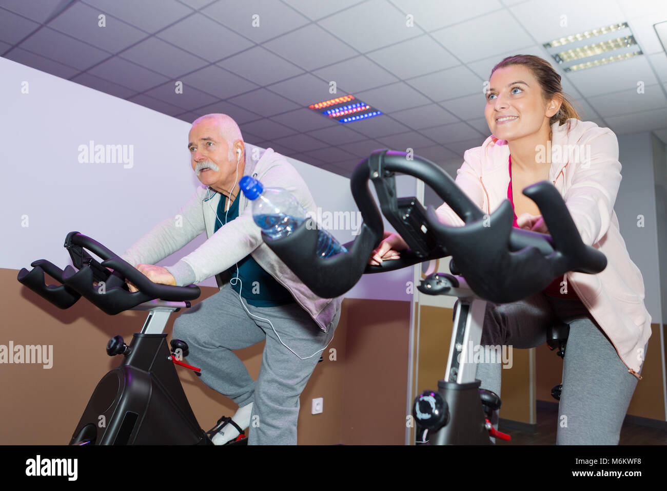 senior man exercising in spinning class in gym Stock Photo - Alamy