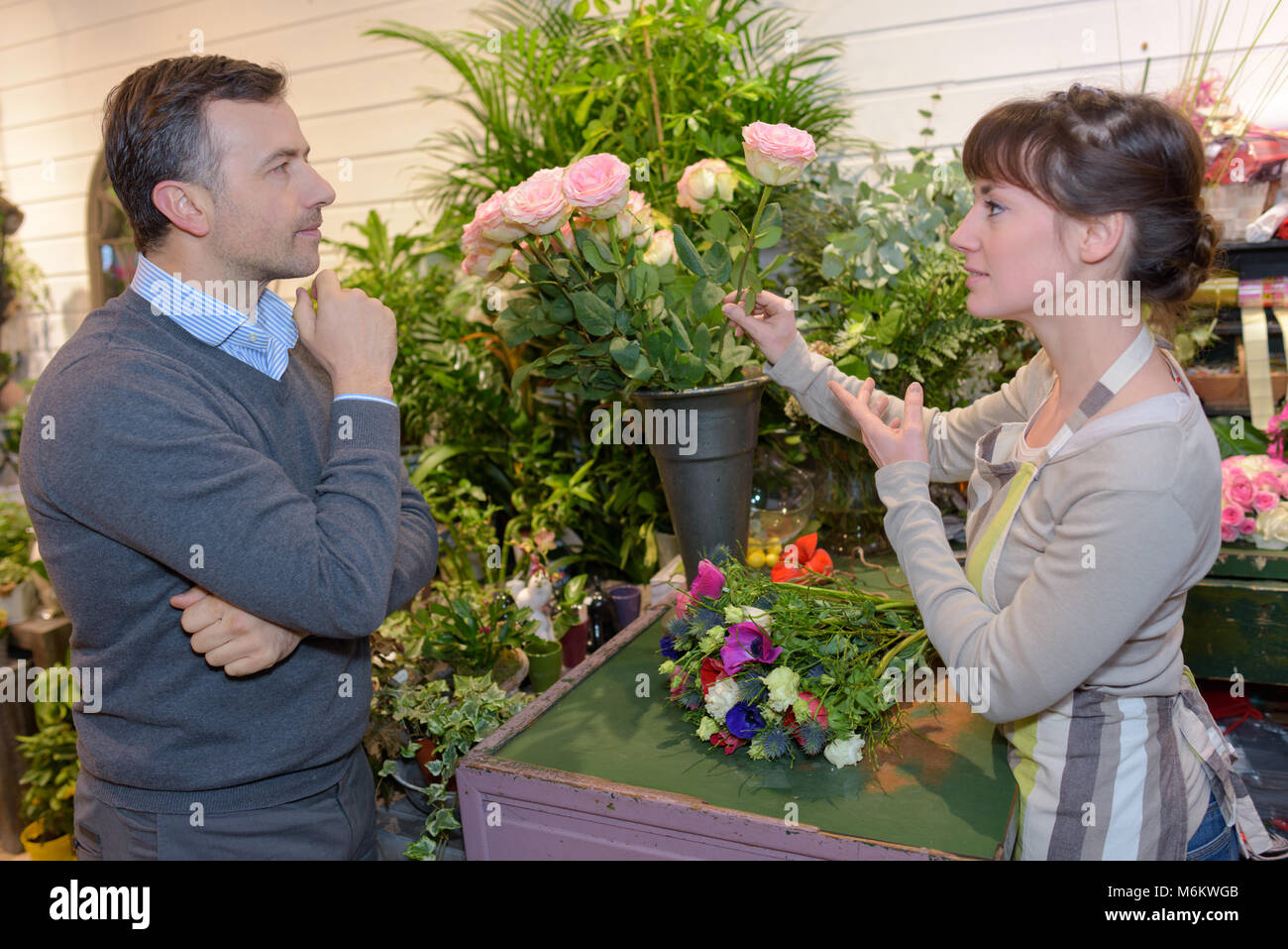 Female florist offering flowers hi-res stock photography and images - Alamy