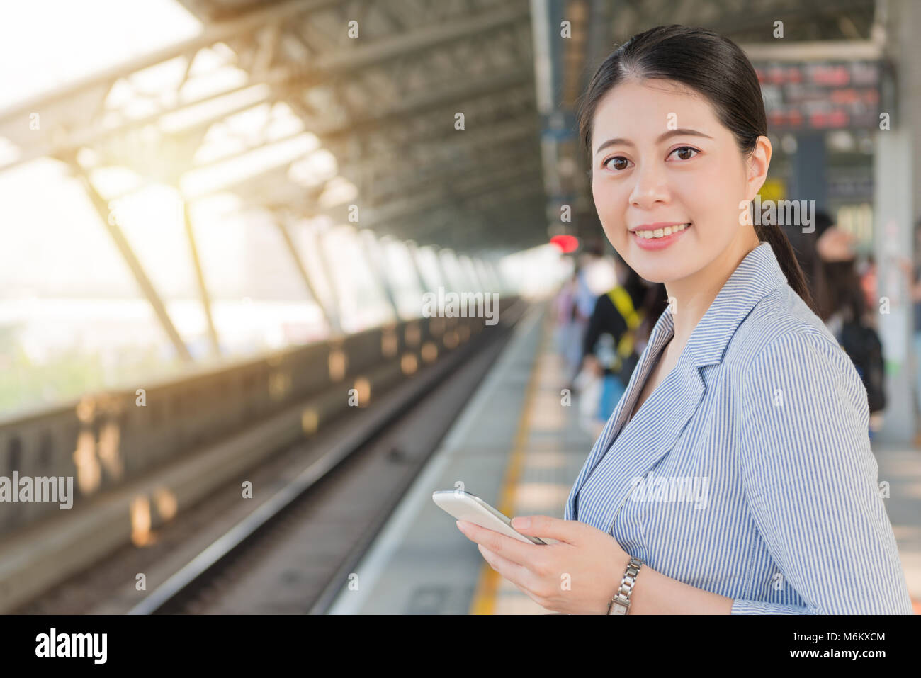 perfect beauty business model girl holding a mobile phone standing on ...
