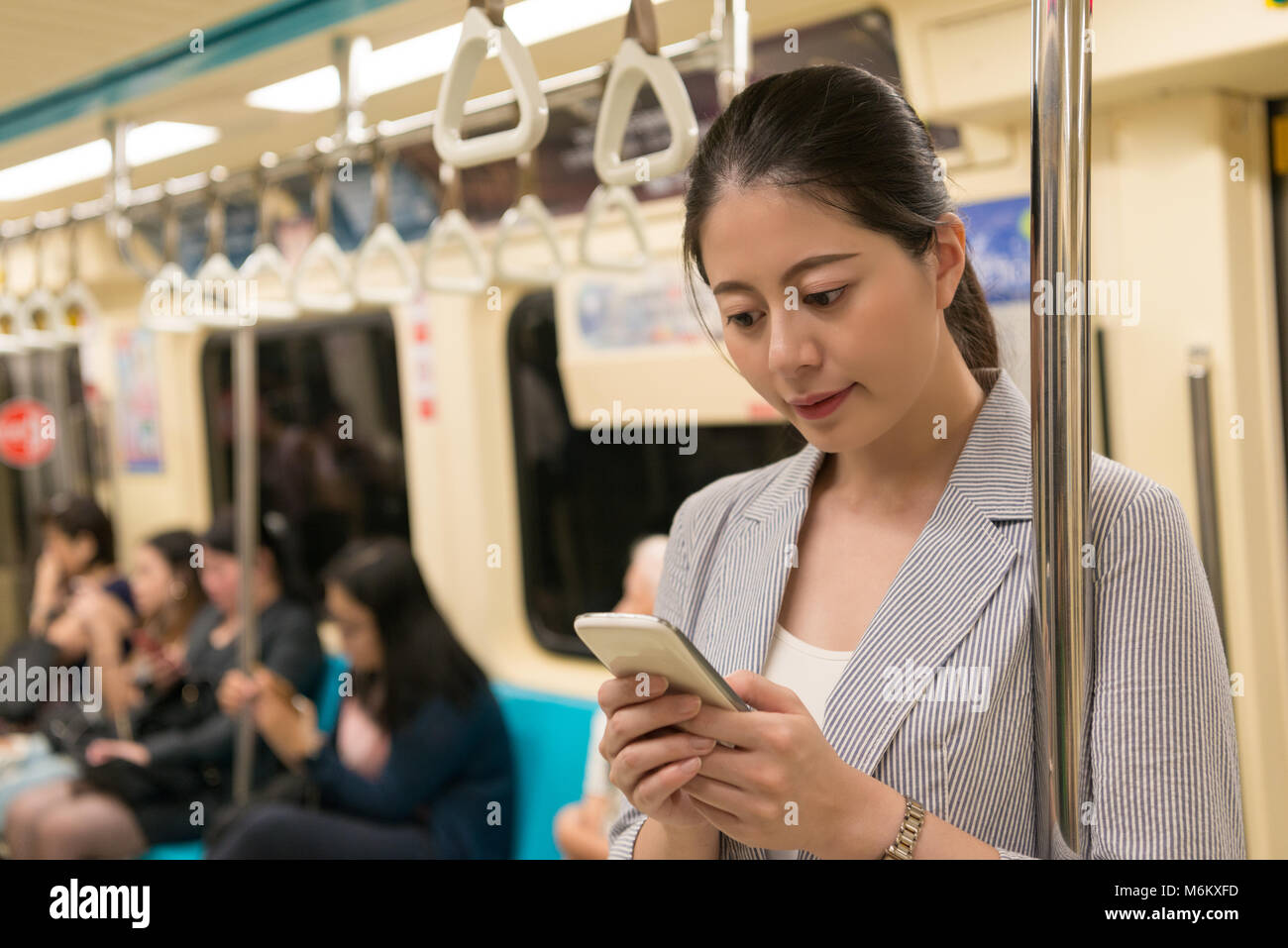 beautiful Asian business woman texting message to her customer standing ...