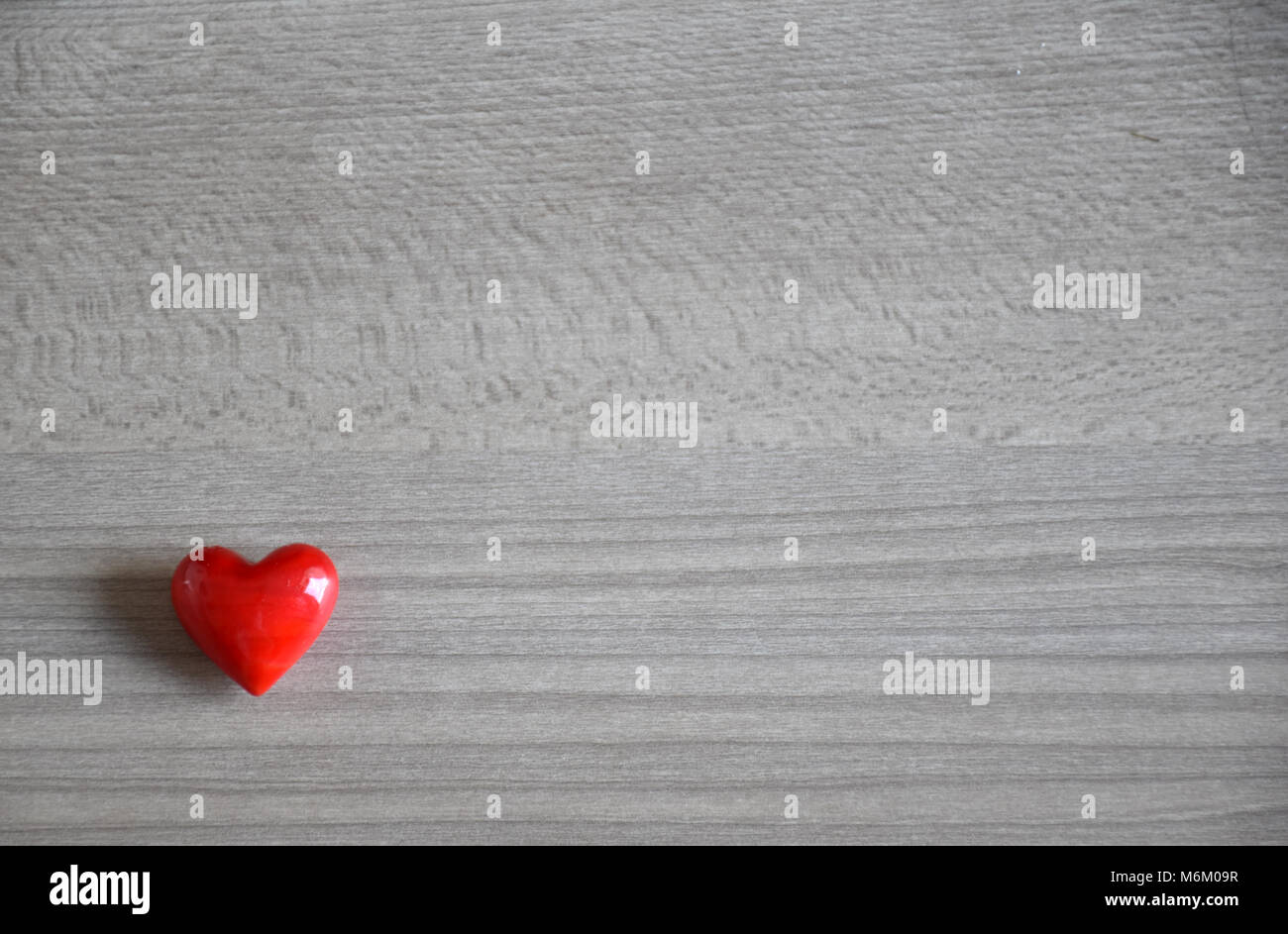 Small red love heart pebble stone against a simple background Stock ...