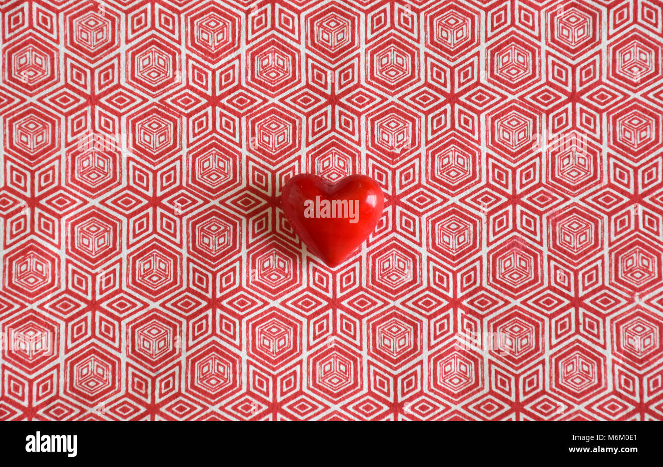 Small red love heart pebble stone against a simple background Stock ...