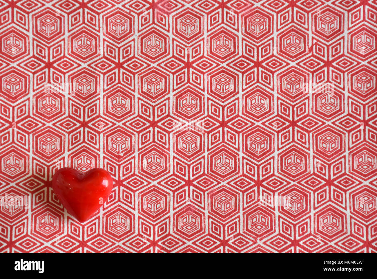 Small red love heart pebble stone against a simple background Stock ...