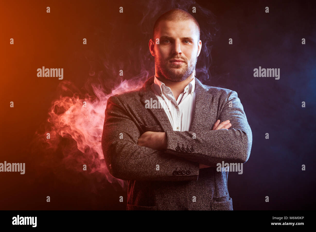 Young intelligent man businessman in white shirt and gray suit looks ...