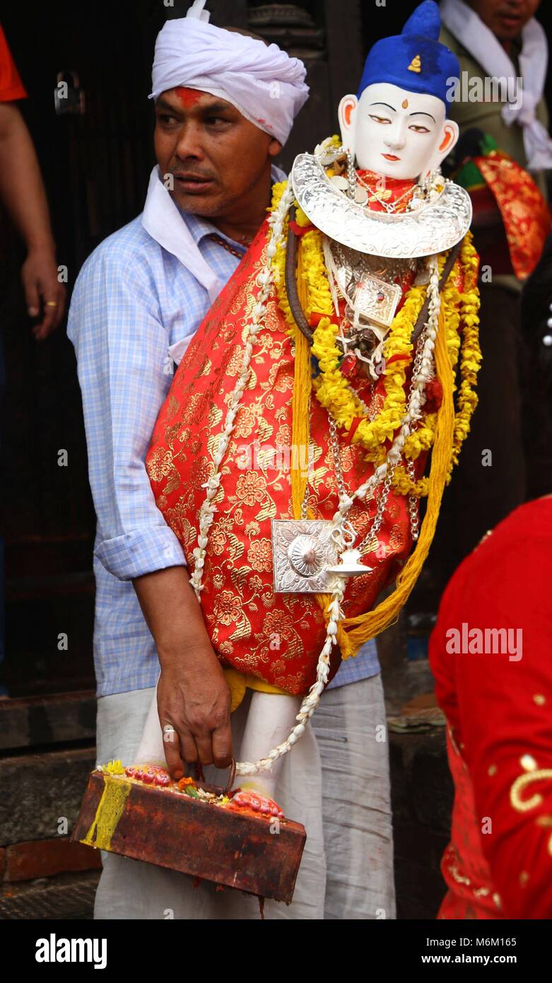 A devotee carries the idol of Machhendranath for placing it in the ...