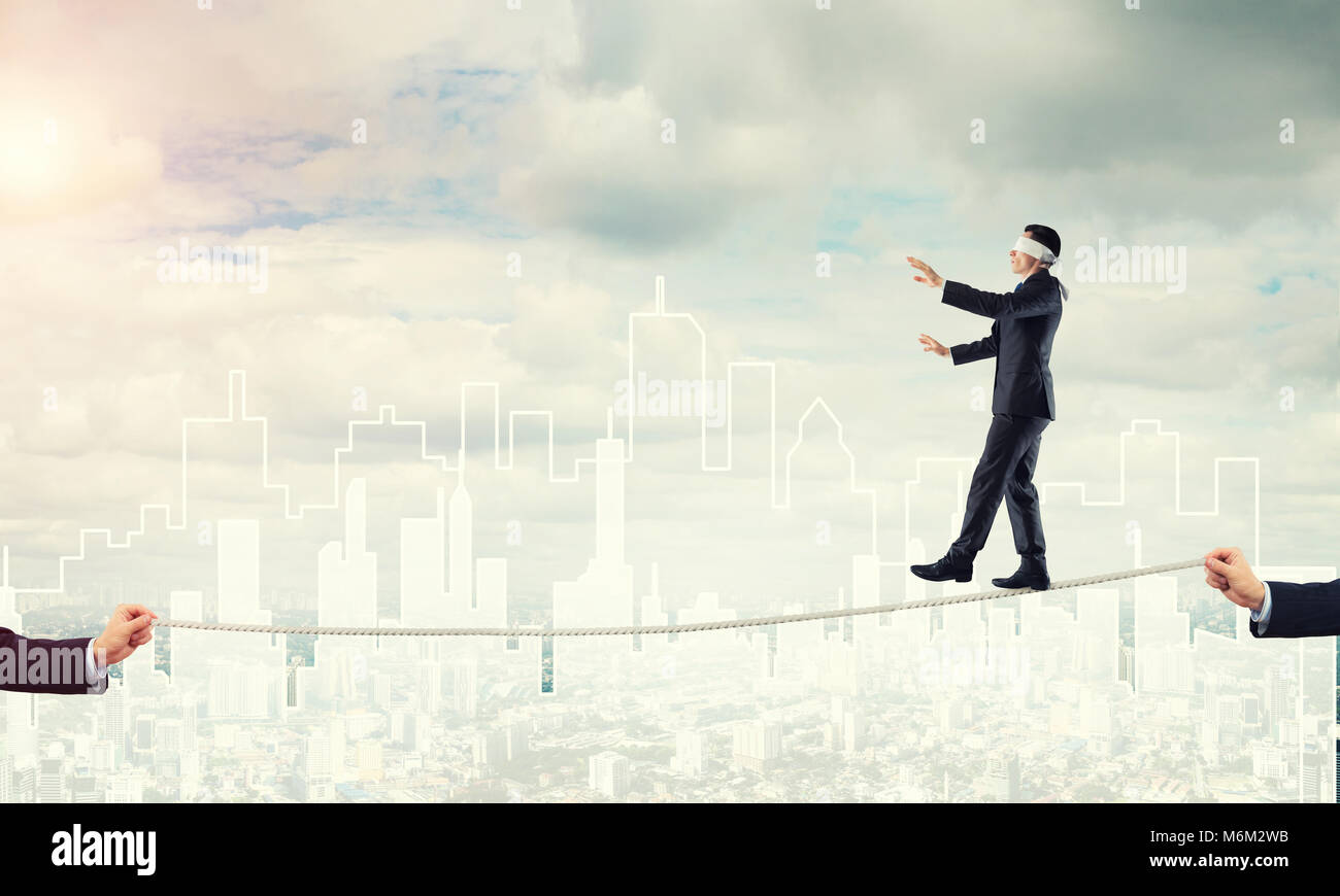 Business concept of risk support and assistance with man balancing on ...