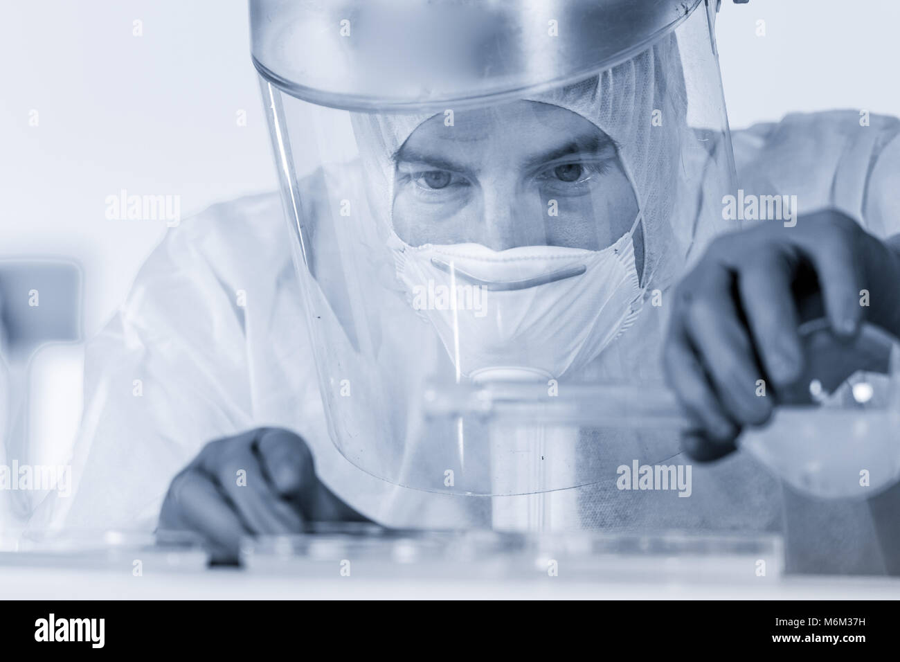 Life scientist researching in bio hazard laboratory. High degree of ...